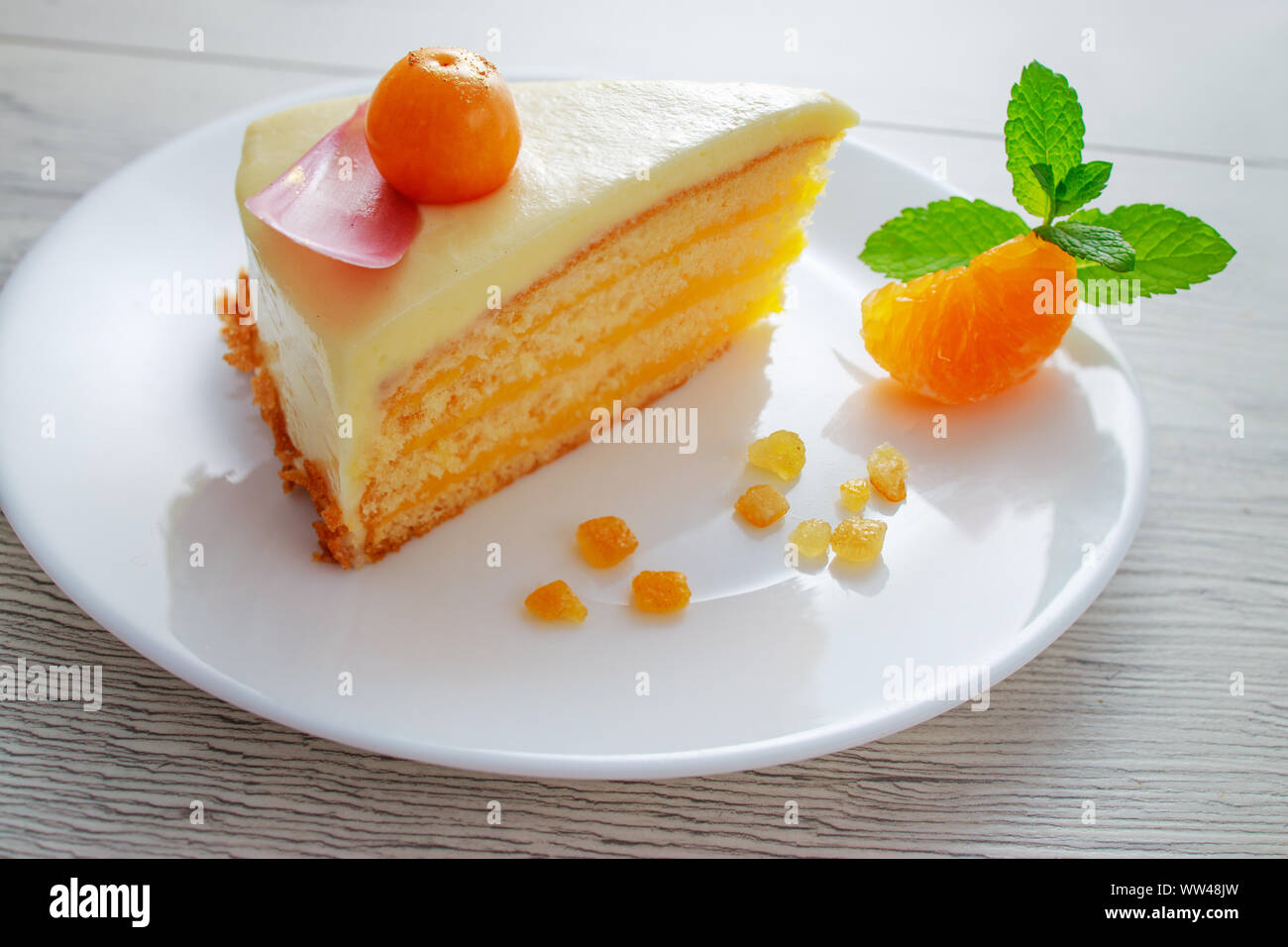 Chocolate cake with physalis fruits, cream, nuts, mousse and mint over ...