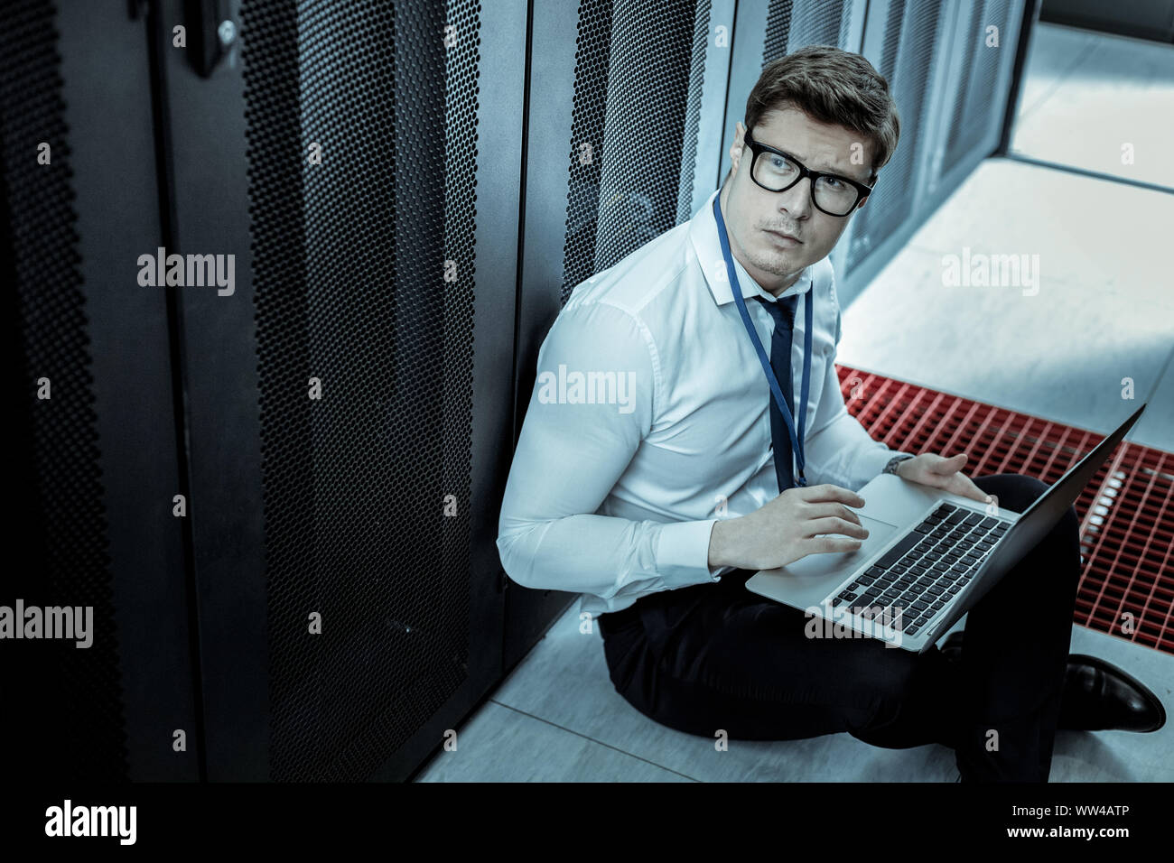Young detective with a laptop looking involved Stock Photo - Alamy