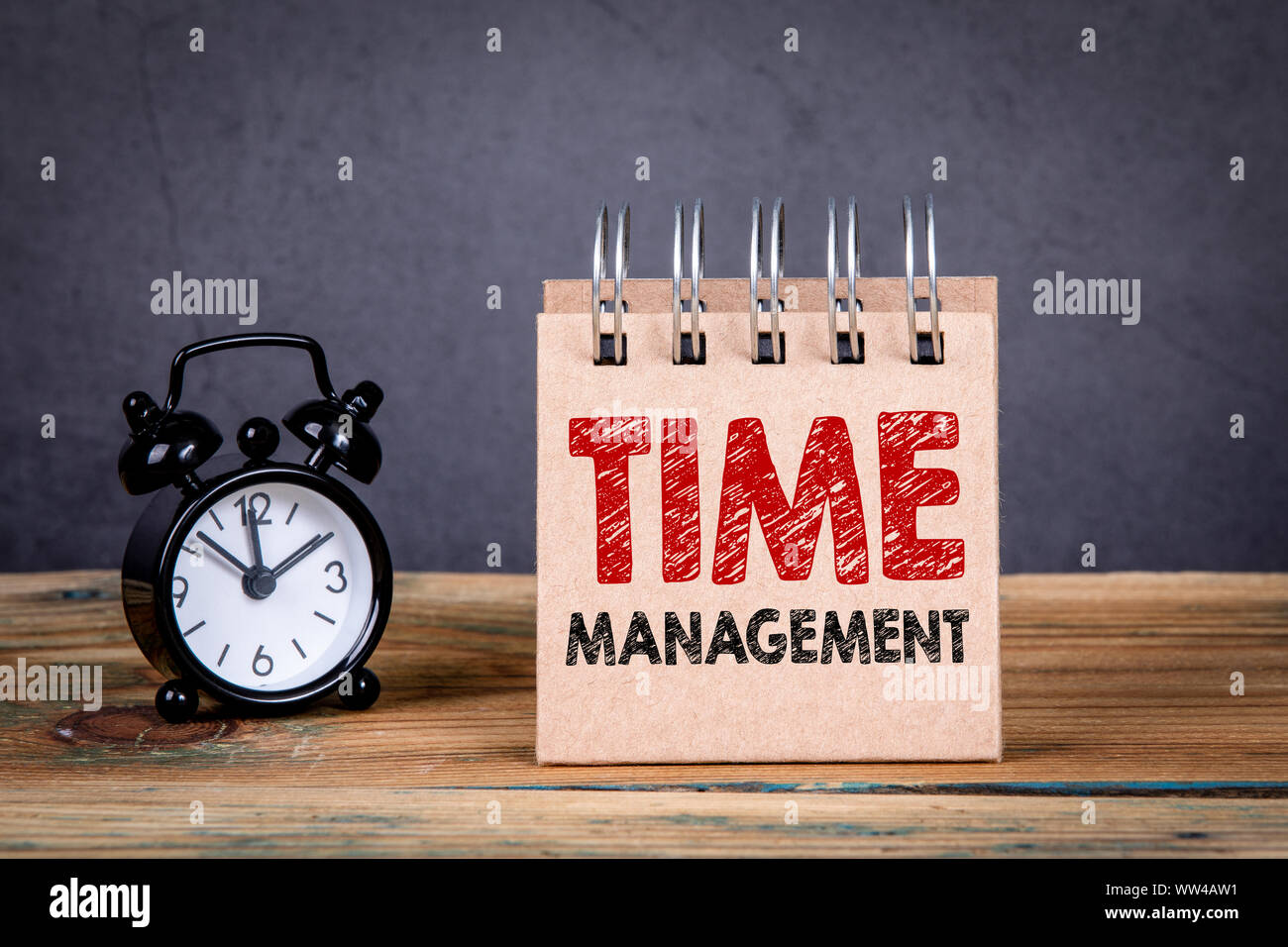 Time management concept. Alarm clock and notebook Stock Photo - Alamy