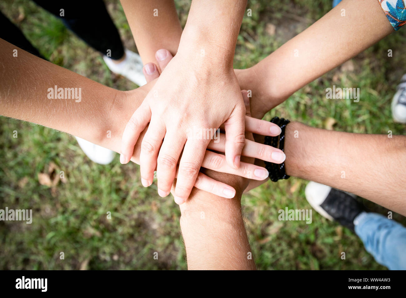 Close up top view of people putting their hands together Stock Photo ...