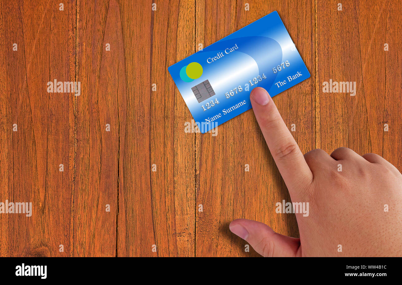 Hand holding credit card on wood table background, online payment ...