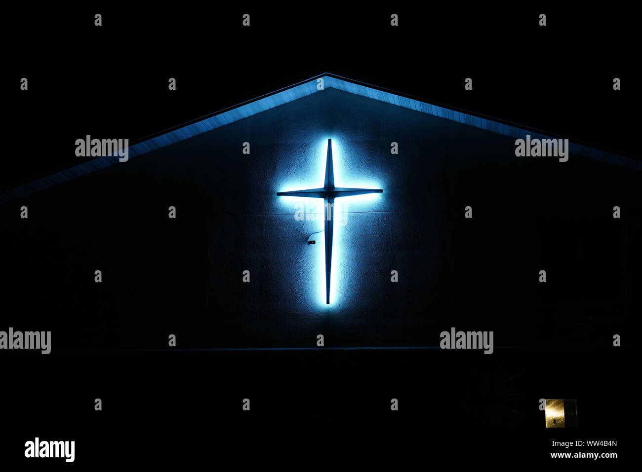 Beautiful Bright Neon Blue Cross on Side of a church building in ...