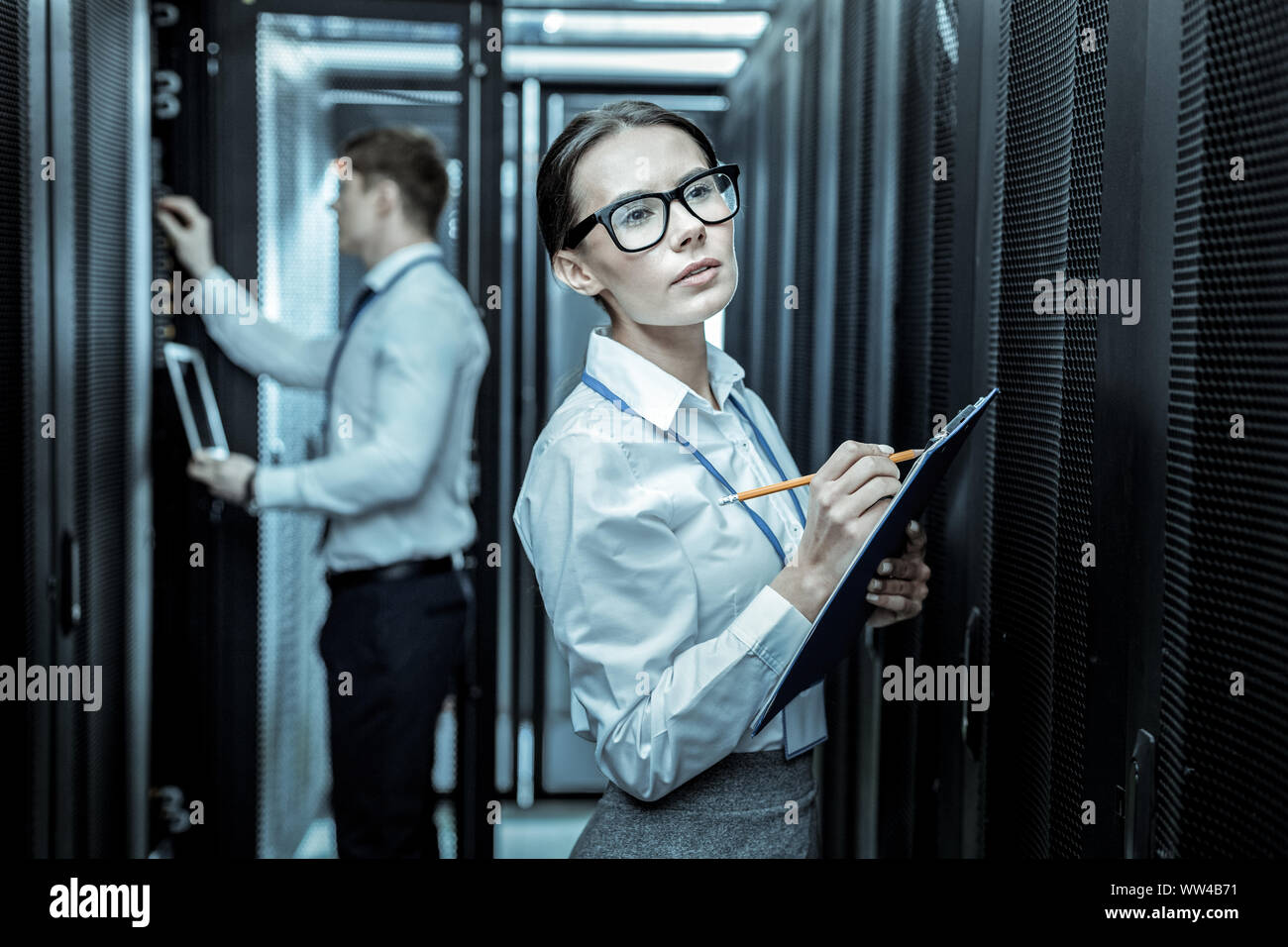Workers of an intelligence agency noting data from the equipment Stock ...