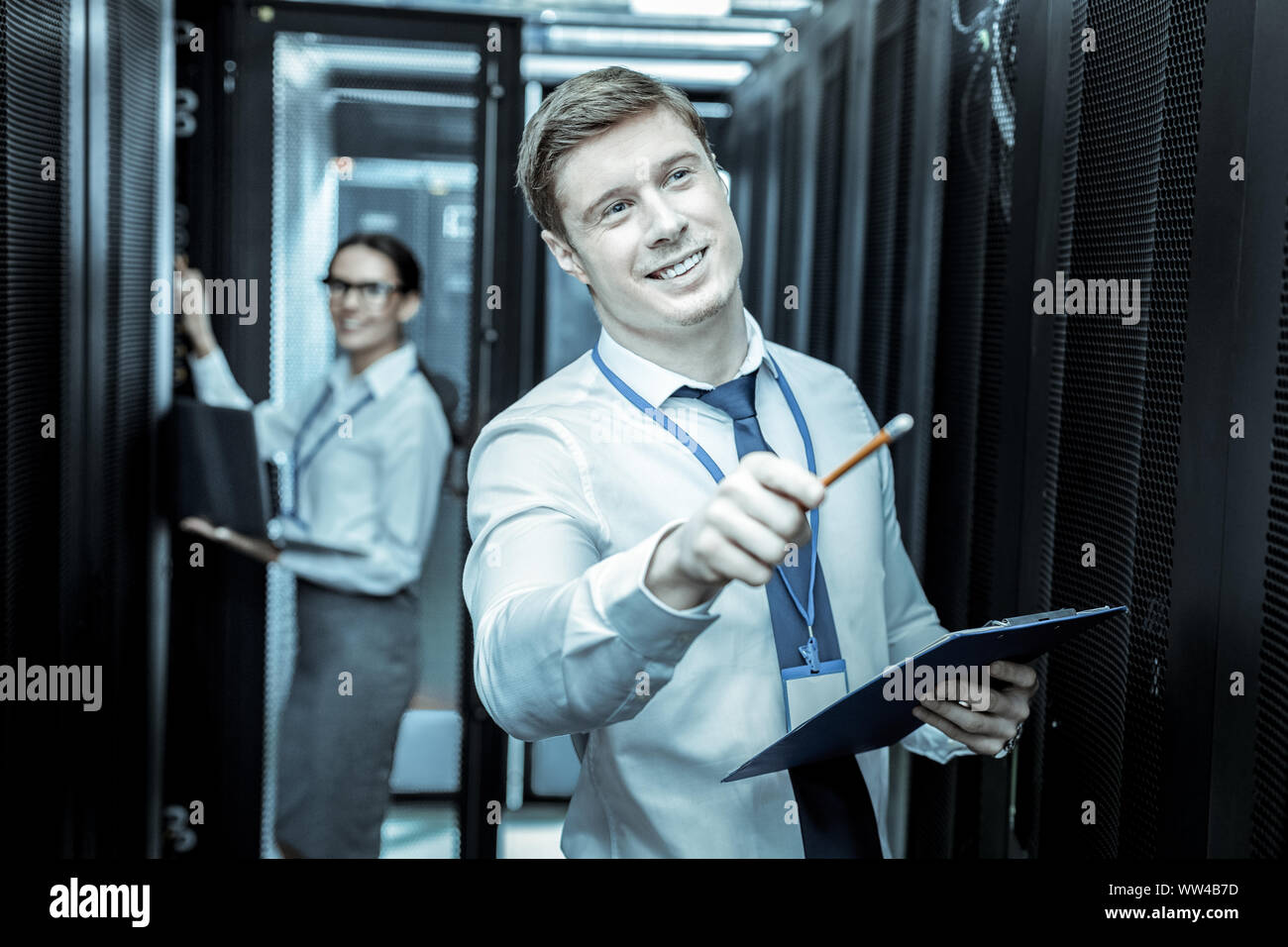 Contented security guard with a notebook feeling good Stock Photo - Alamy