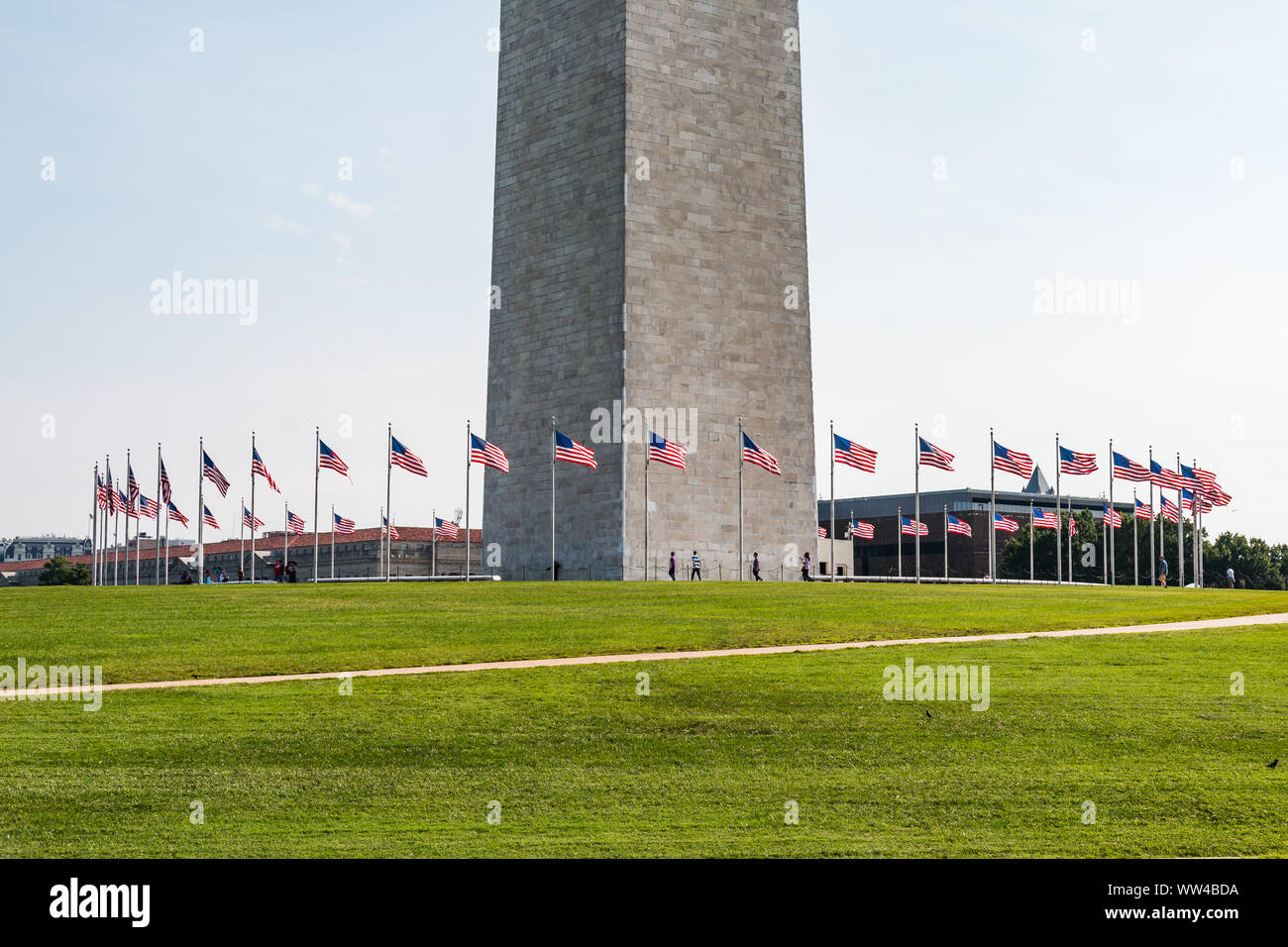 People walk among the 50 American flags encircling the base of the ...