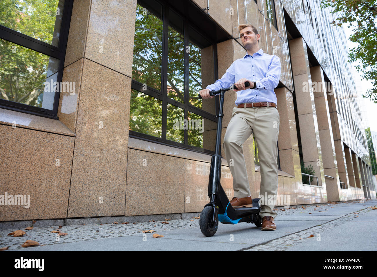 Modern man riding scooter hi-res stock photography and images - Alamy