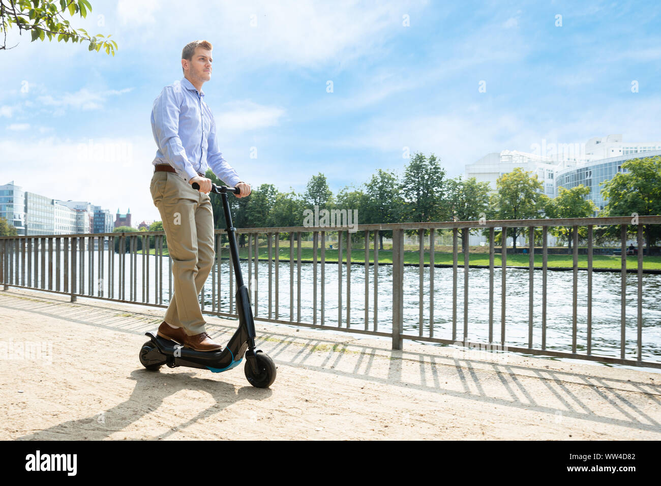 Young Man Riding An Electric Kick Scooter Stock Photo - Alamy