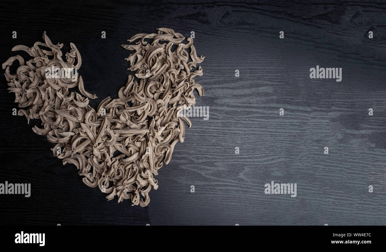 pasta from rye whole grain, heart shape from pasta, copy space Stock ...