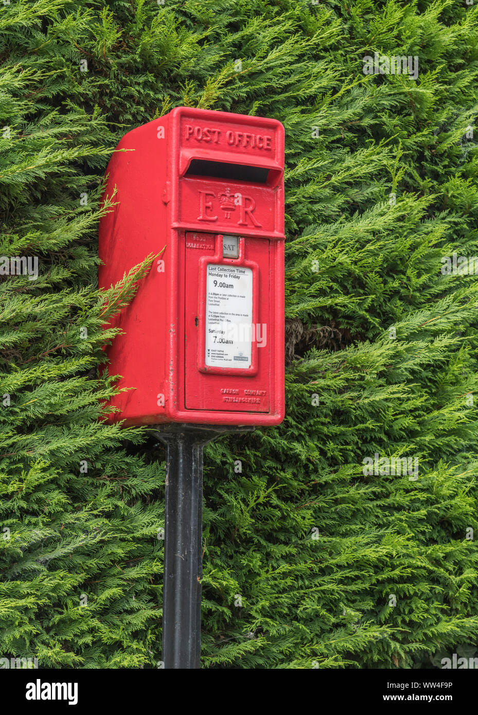 Royal Mail red post box / pillar box in country lane (in town of ...