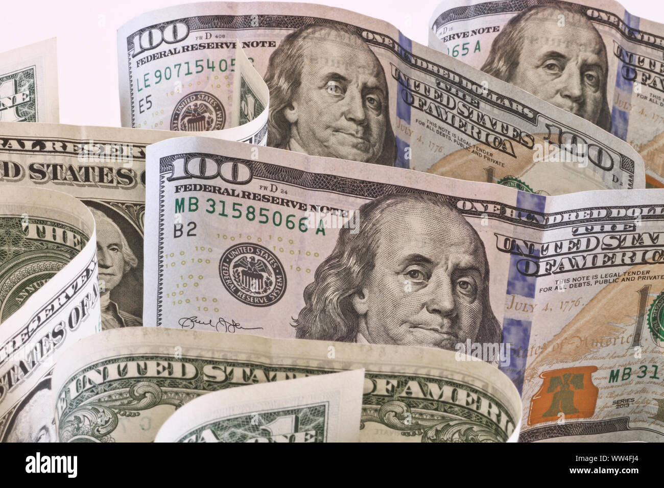 American currency - one-dollar and hundred-dollar bills stand on a ...