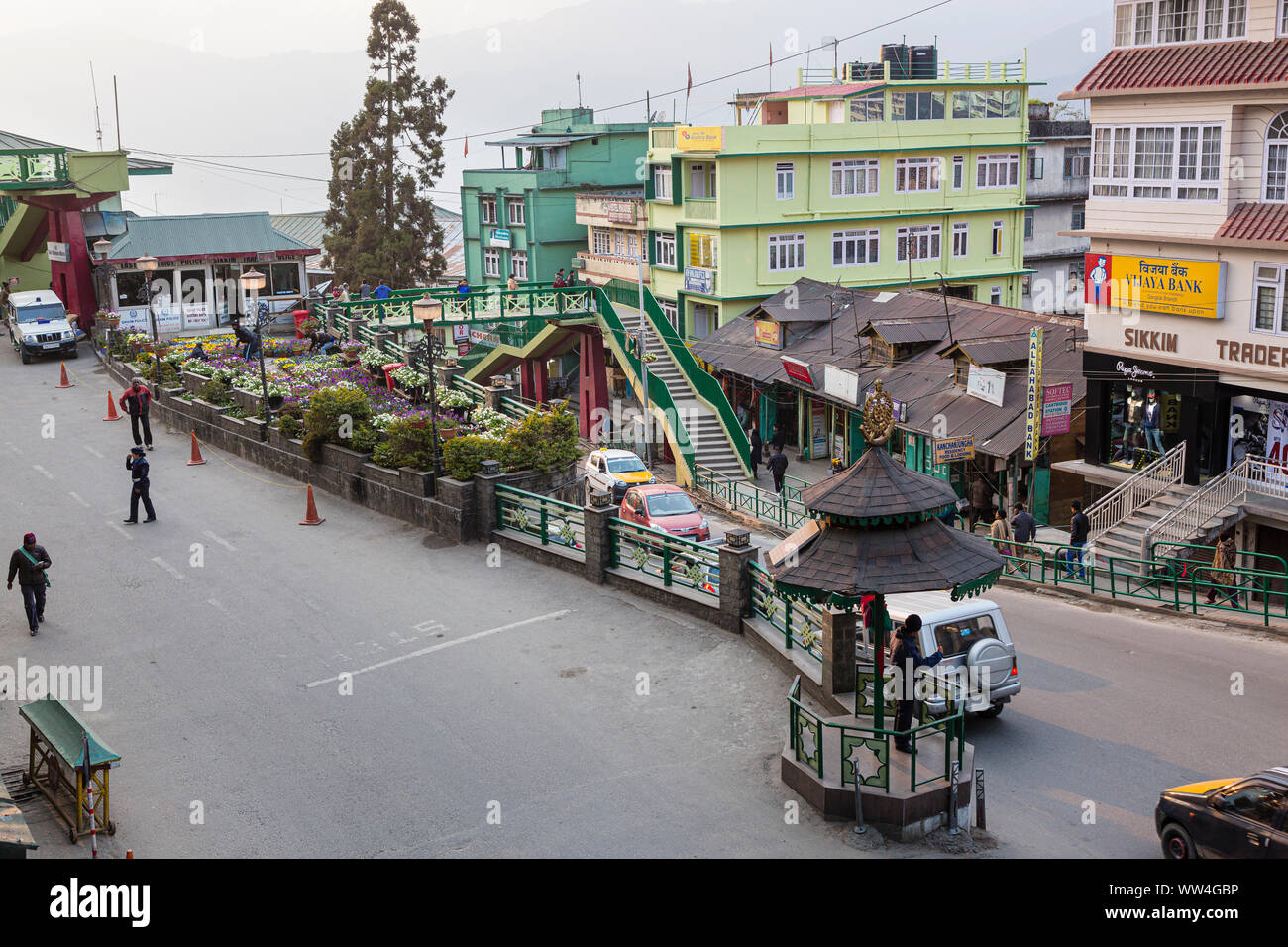 View of pedestrians and vehicles at a street in the city of Gangtok in ...