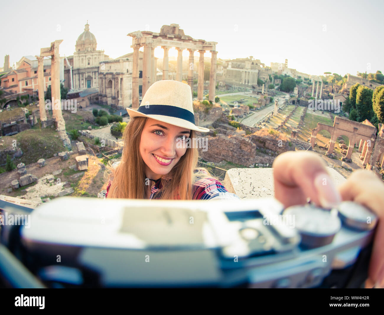 Happy young blonde woman with long hair and blue eyes taking selfies ...