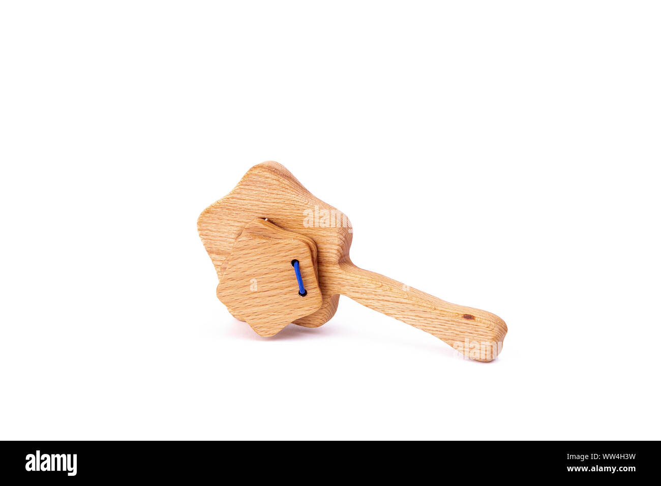 Photo of wooden rattle in the shape of a star on a white isolated ...