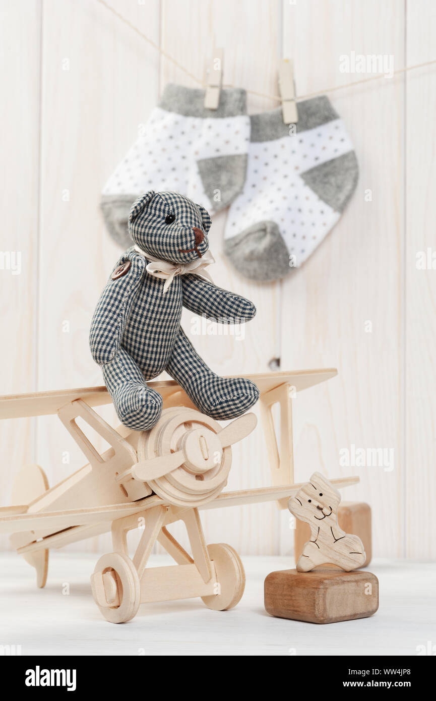 Cute teddy bear on wooden background with wooden baby toys Stock Photo ...