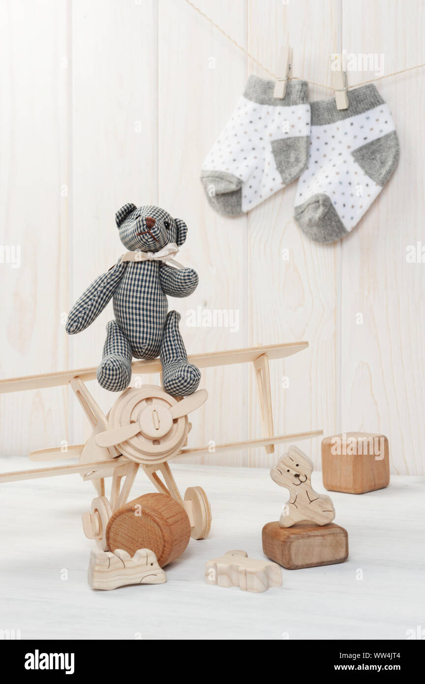 Cute teddy bear on wooden background with wooden baby toys Stock Photo ...