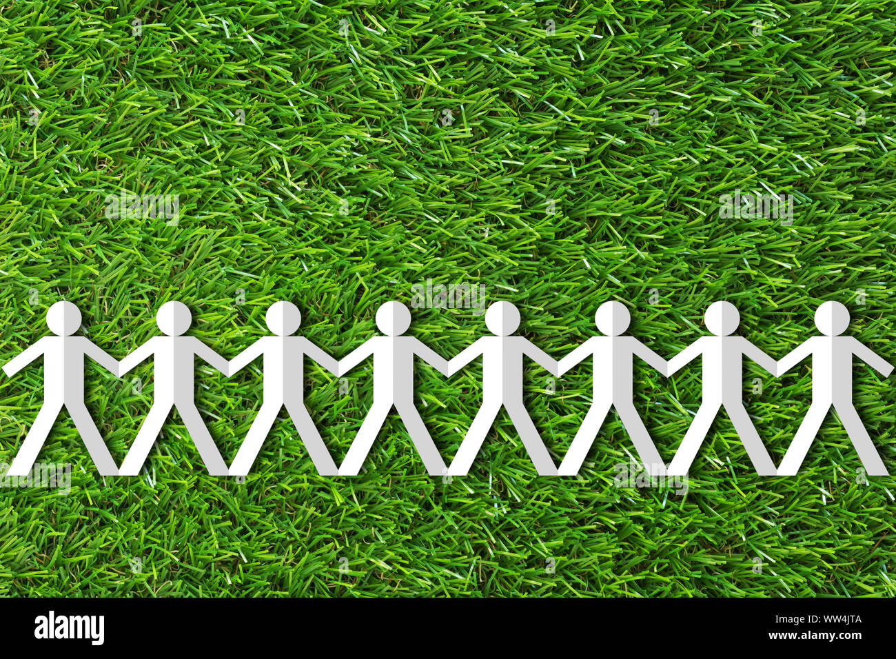 Business teamwork concept, paper cut people on green grass background ...