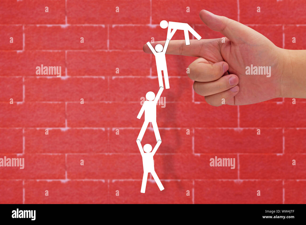 Business teamwork concept, paper cut people climbing on red brick wall ...