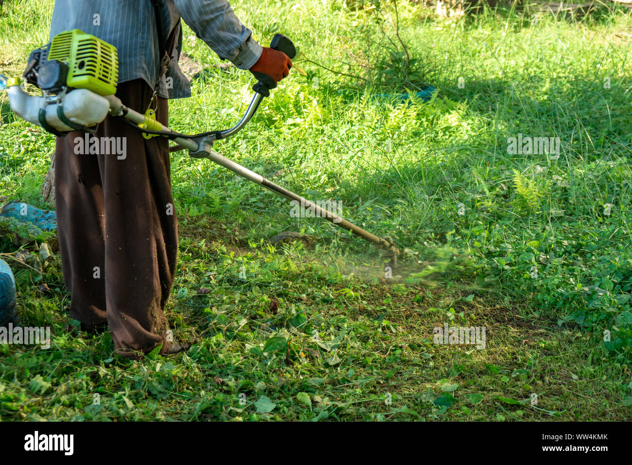 The gardener cutting grass by lawn mower, lawn care. Nature Stock Photo ...
