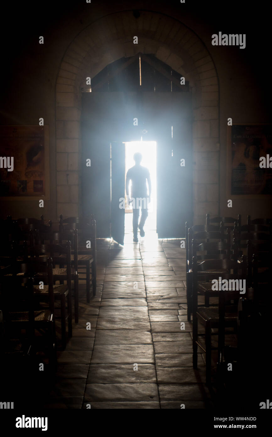 Open door with incoming man in the Eglise Saint-Pierre et Cloitre Stock ...
