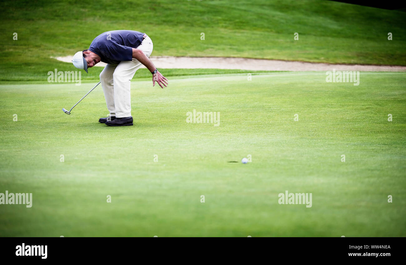 Golf ball just missed hole Stock Photo - Alamy