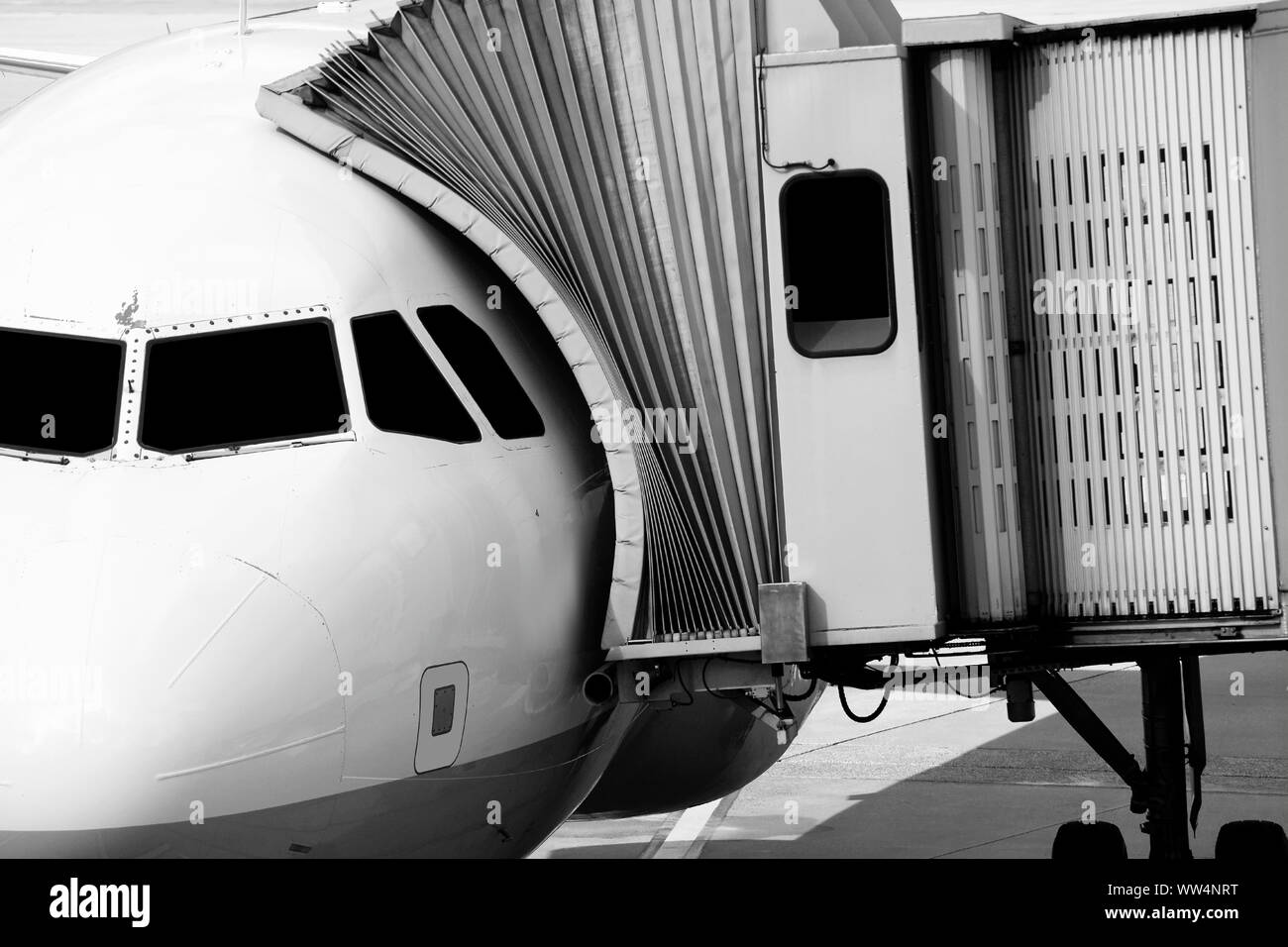 The front view of an airplane with docked jetway Stock Photo - Alamy
