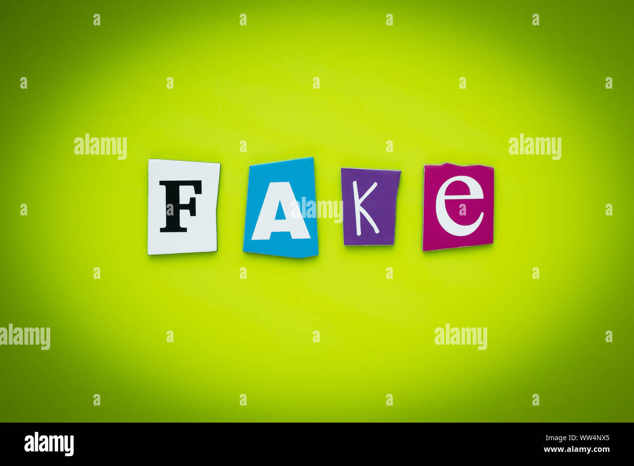 Single word - fake. Text on yellow and green background. Message on ...