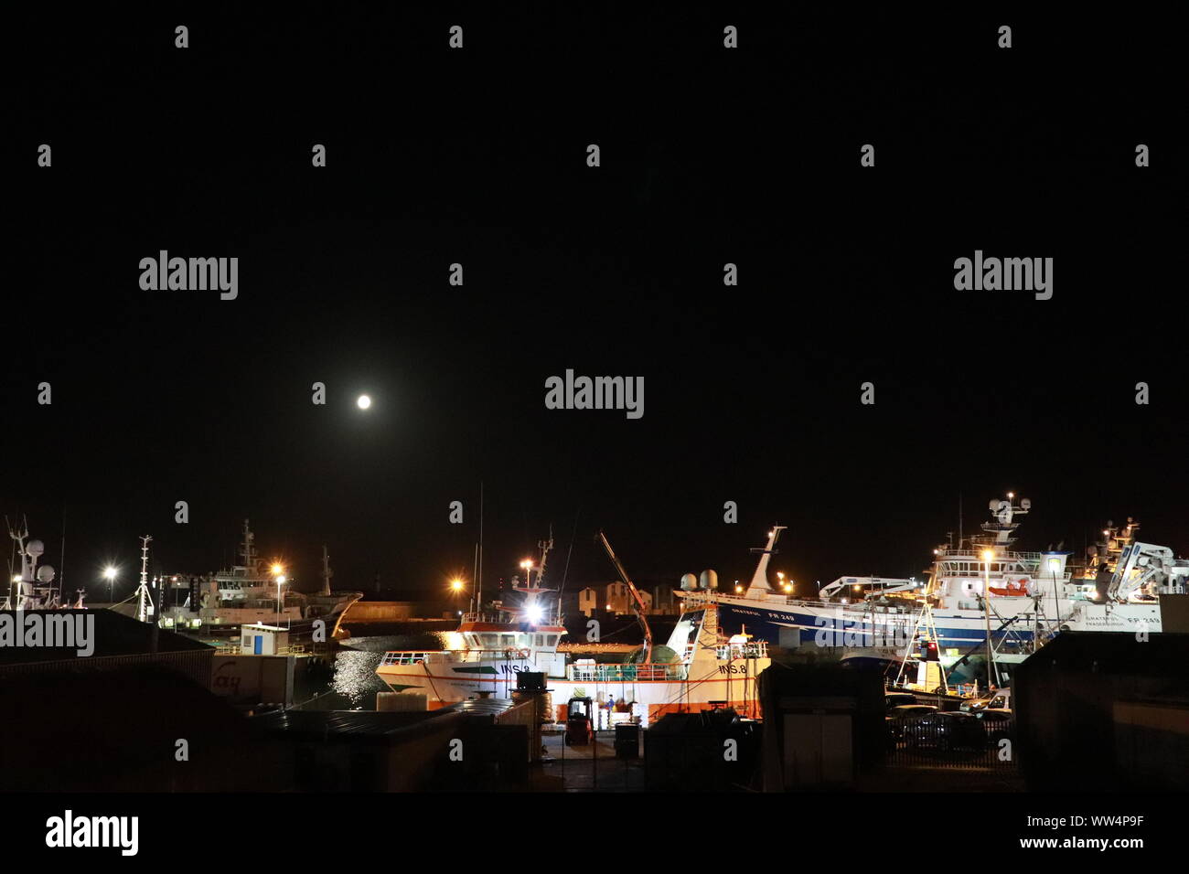 Fishing boats in harbour at night Stock Photo - Alamy