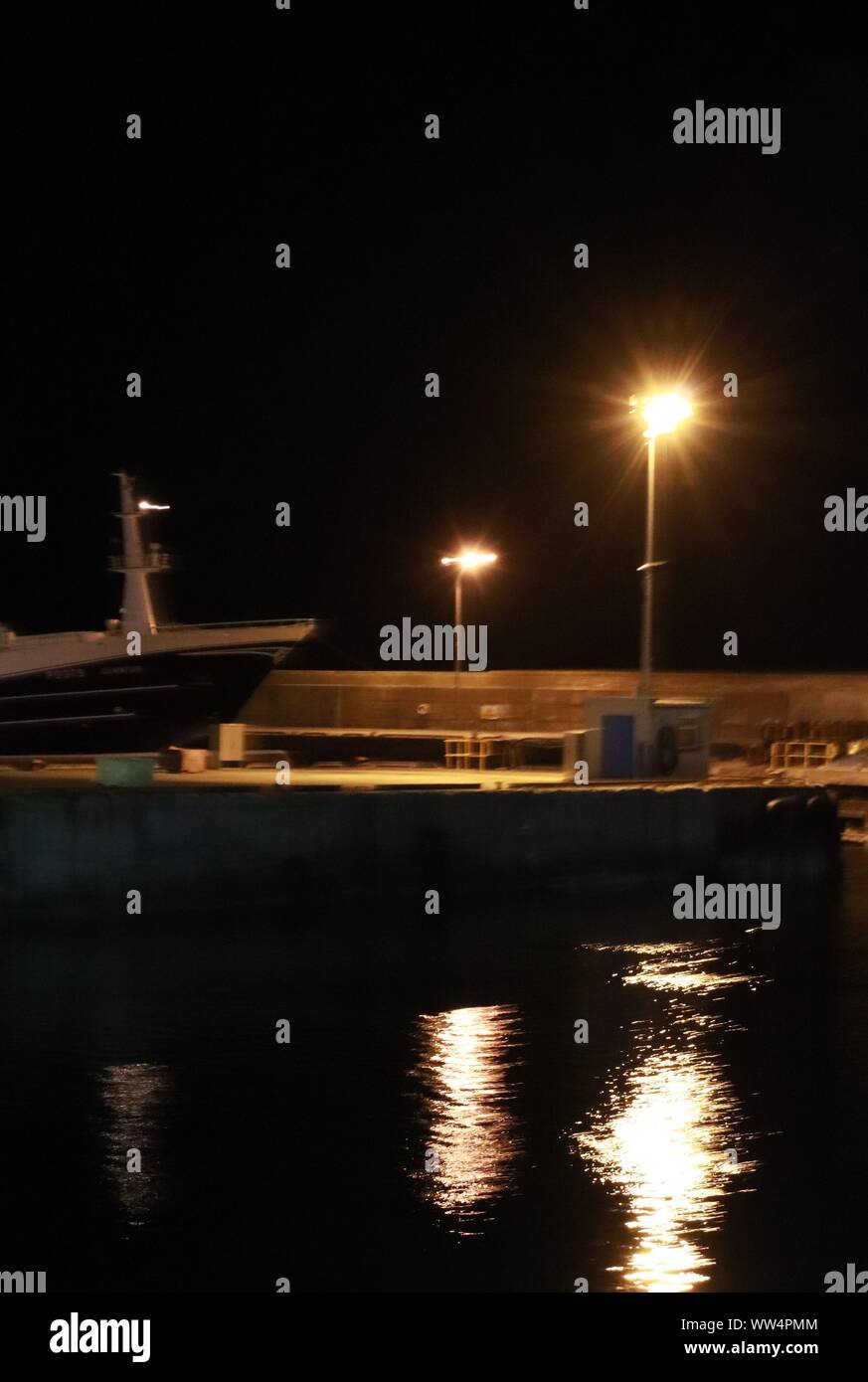 Fishing boats in harbour at night Stock Photo - Alamy