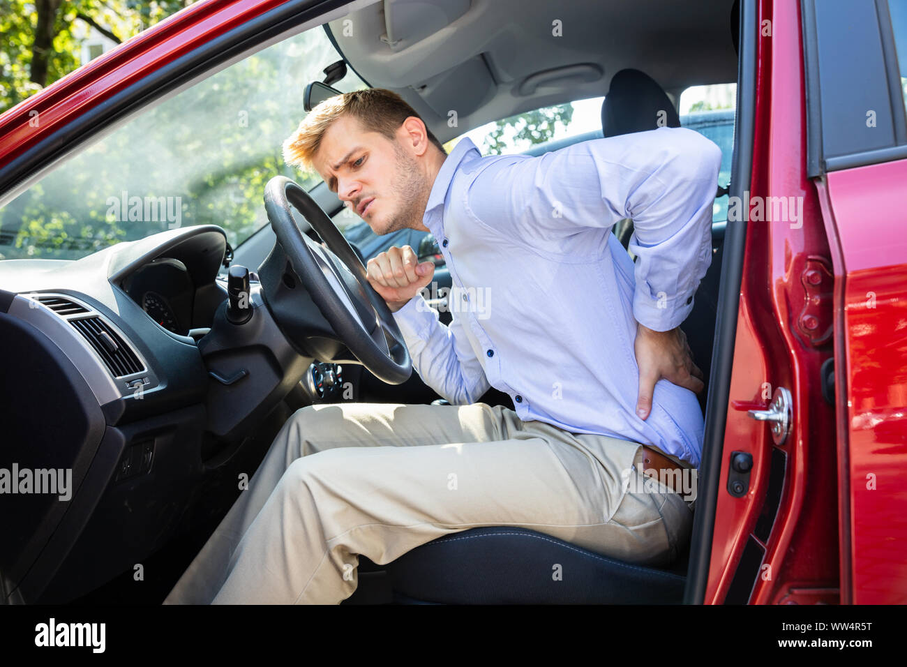 Driver Standing Having Backpain After Driving Car Stock Photo - Alamy