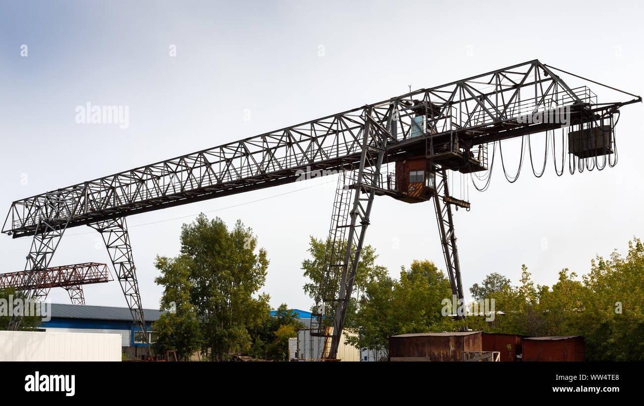 large metal gantry crane at a construction site, in the background ...