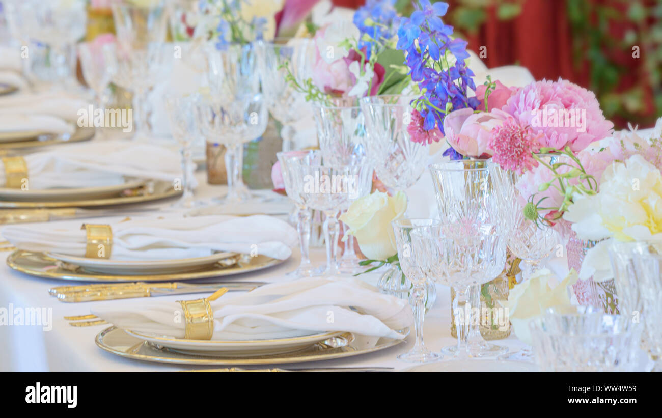 Catering table set service with silverware, napkin and glass at ...