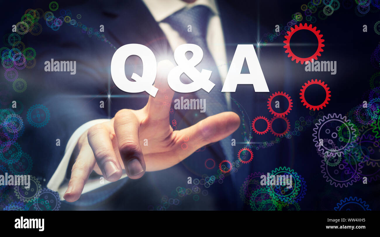 A businessman pressing a Questions and Answers business concept on a ...