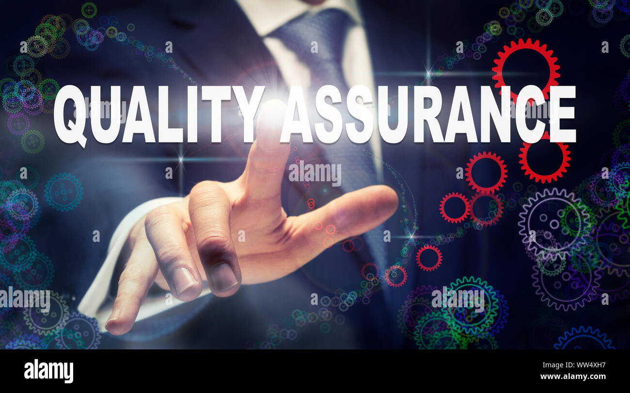 A businessman pressing a Quality Assurance business concept on a ...