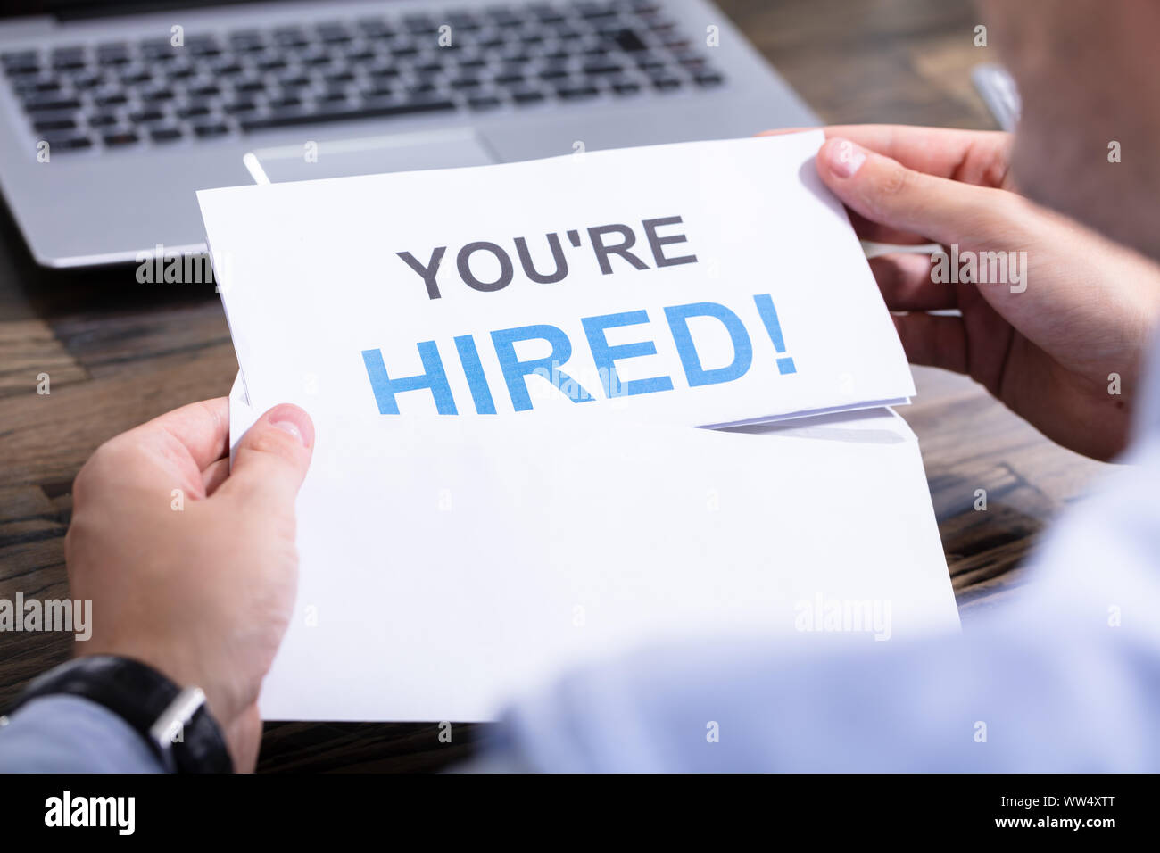 Man Opening White Envelope With You Are Hired Text Stock Photo - Alamy