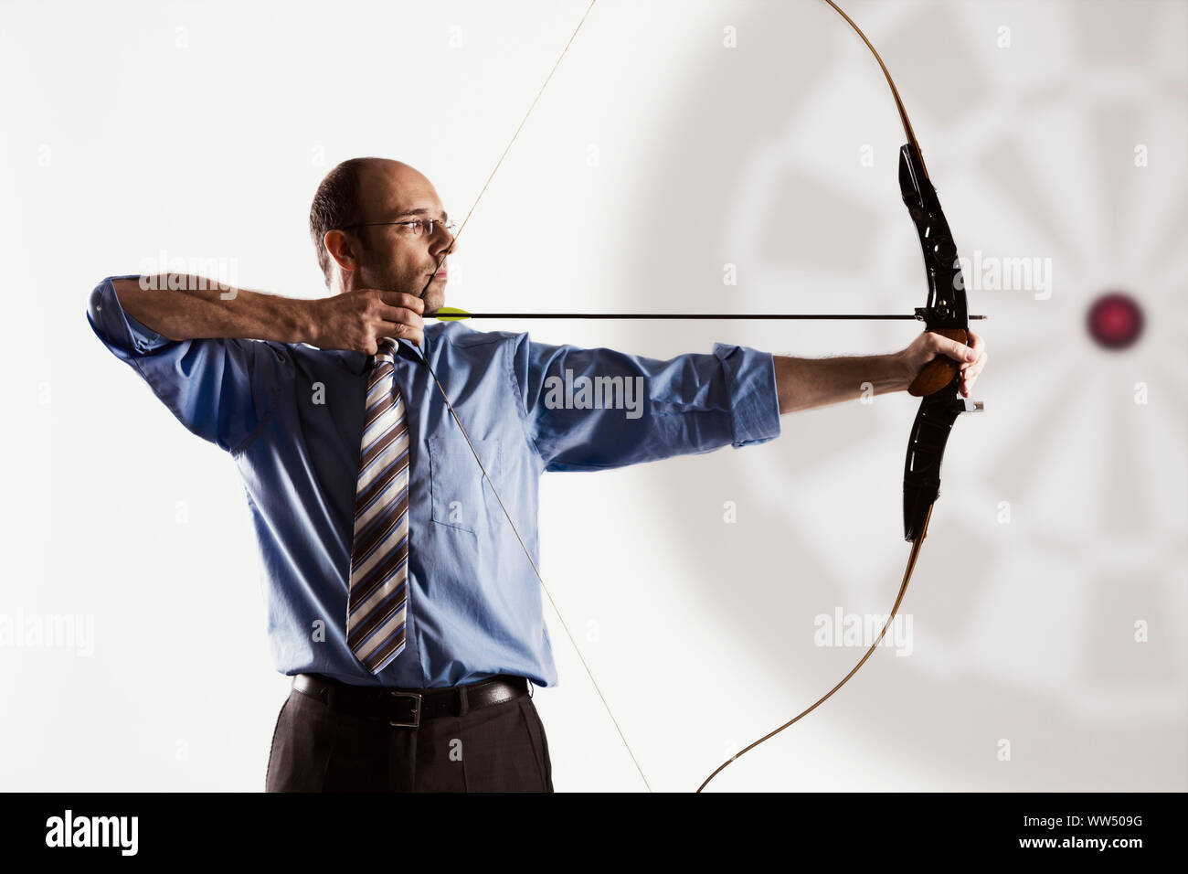 Business executive aiming at target Stock Photo - Alamy