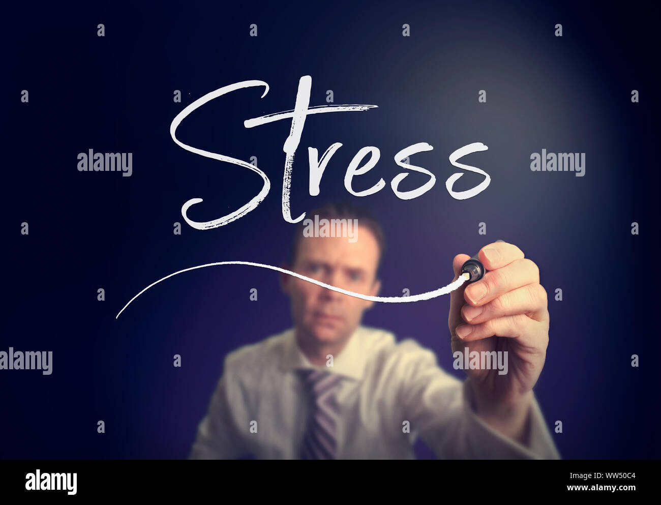 A businessman writing a Stress concept with a white pen on a clear ...