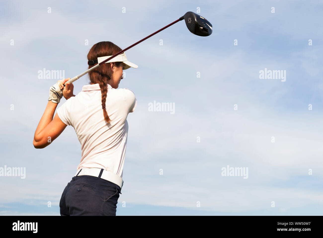 Golf player teeing off Stock Photo - Alamy