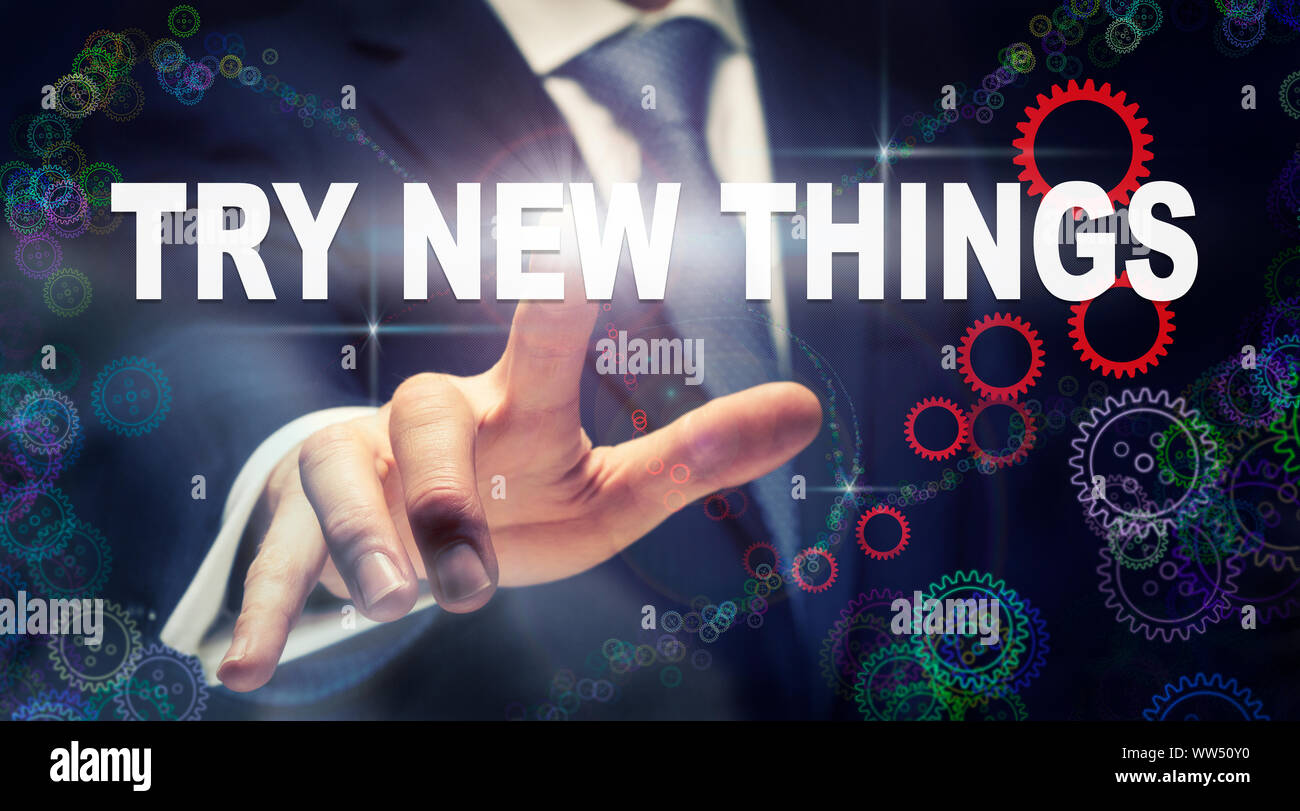 A businessman pressing a Try New Things business concept on a graphical ...