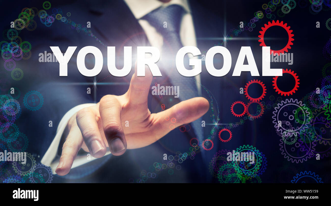 A businessman pressing a Your Goal business concept on a graphical ...