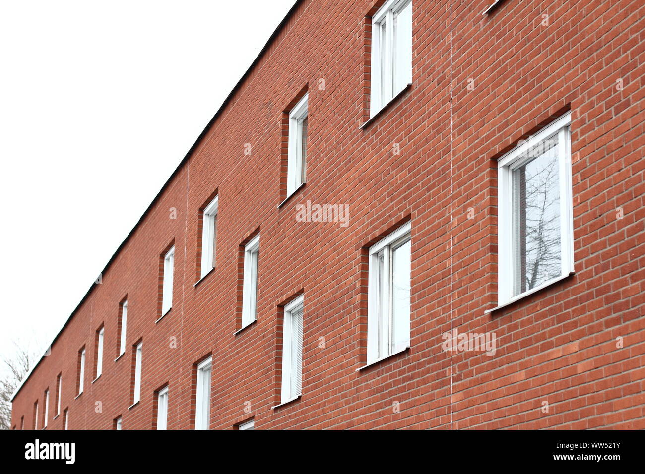 Brick building with many windows Stock Photo - Alamy