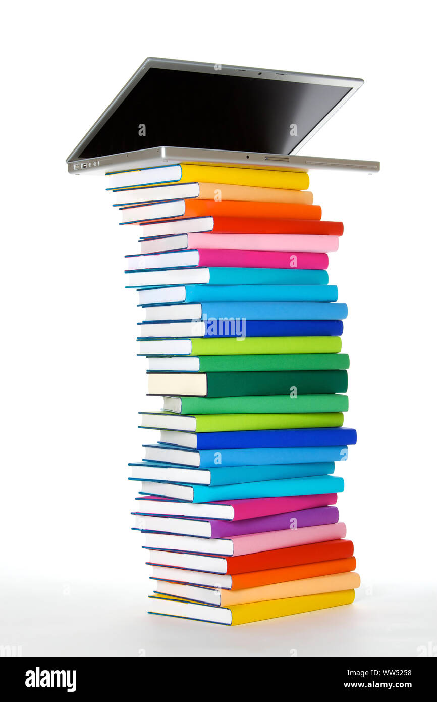 Laptop on book stack, side view Stock Photo - Alamy