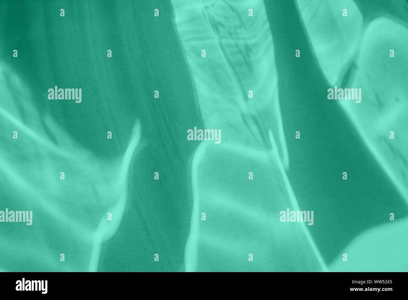 Trendy mint colored abstract background with light and shadows caustic ...