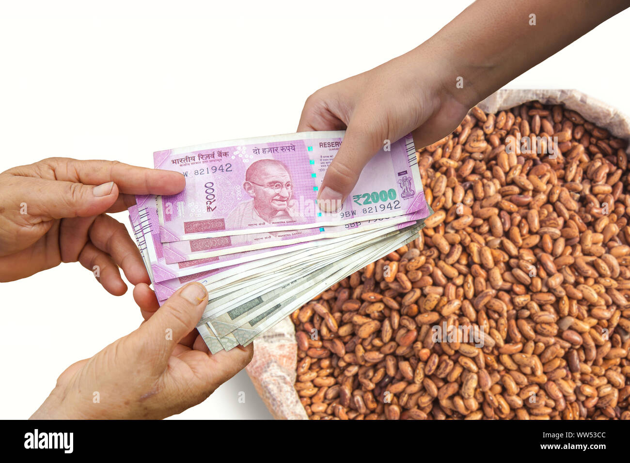 Hand Giving Indian 500 and 2000 Rupee Bank Notes over bag, Burlap full ...