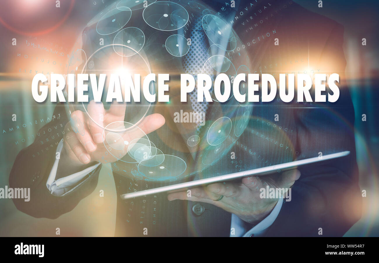 A hand selecting a Grievance Procedures business concept on a futuristic computer display Stock ...