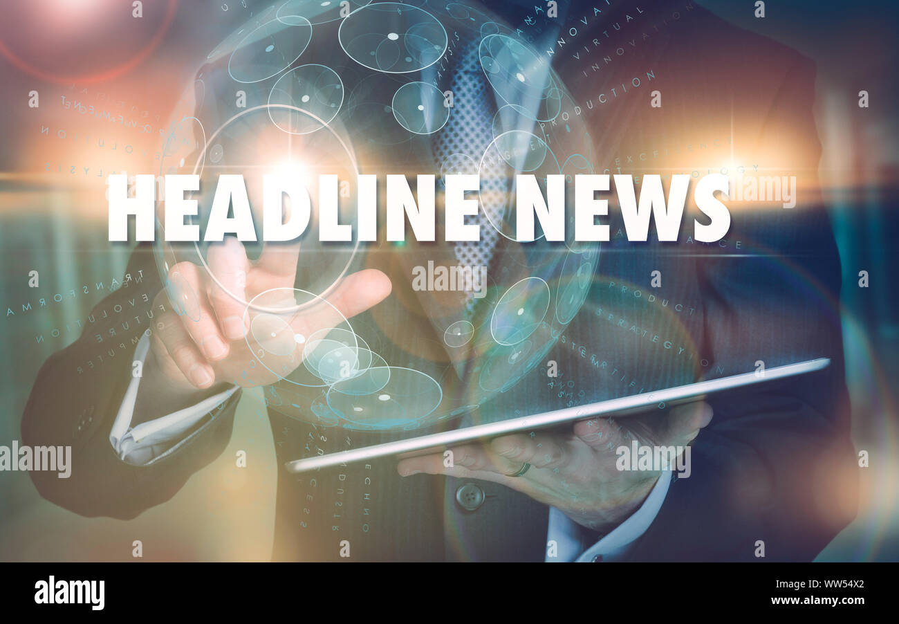 A hand selecting a Headline News business concept on a futuristic ...