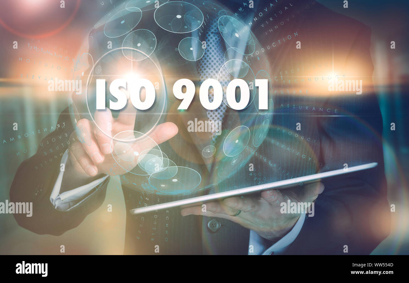 A hand selecting a ISO 9001 business concept on a futuristic computer ...