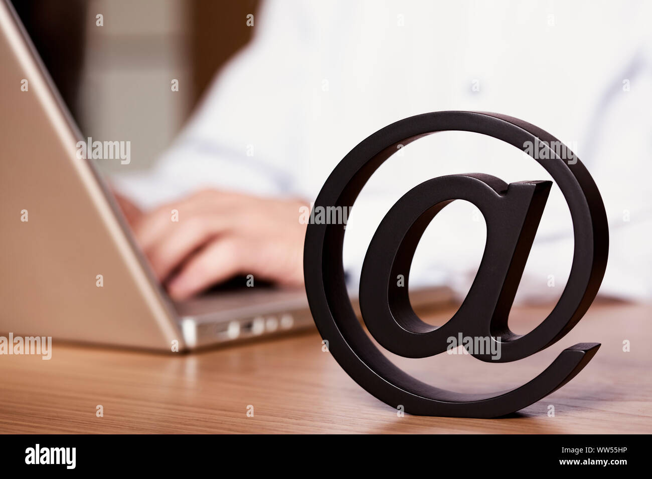 At symbol with laptop Stock Photo - Alamy