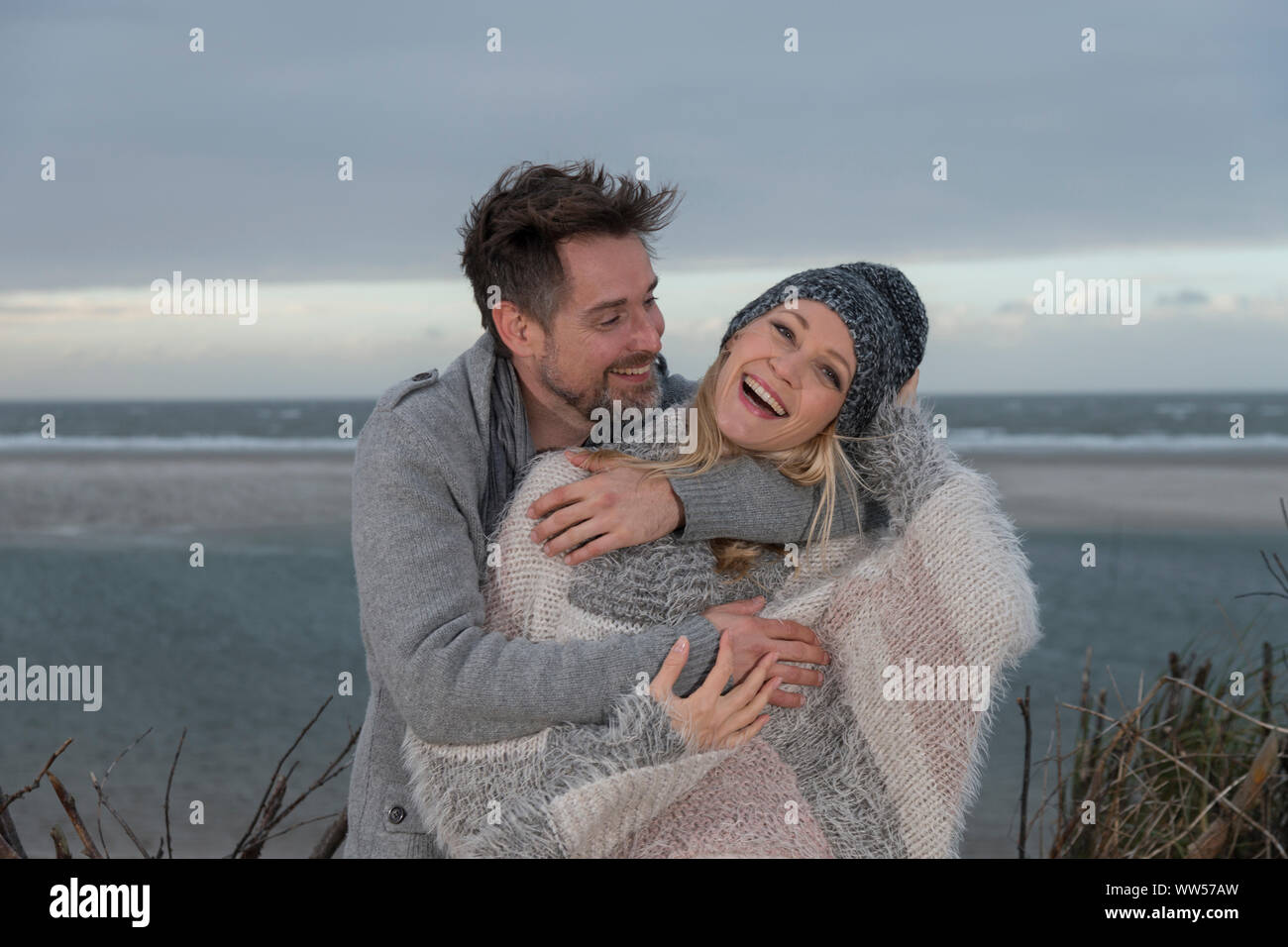 Man embracing woman from the back by the sea hi-res stock photography ...