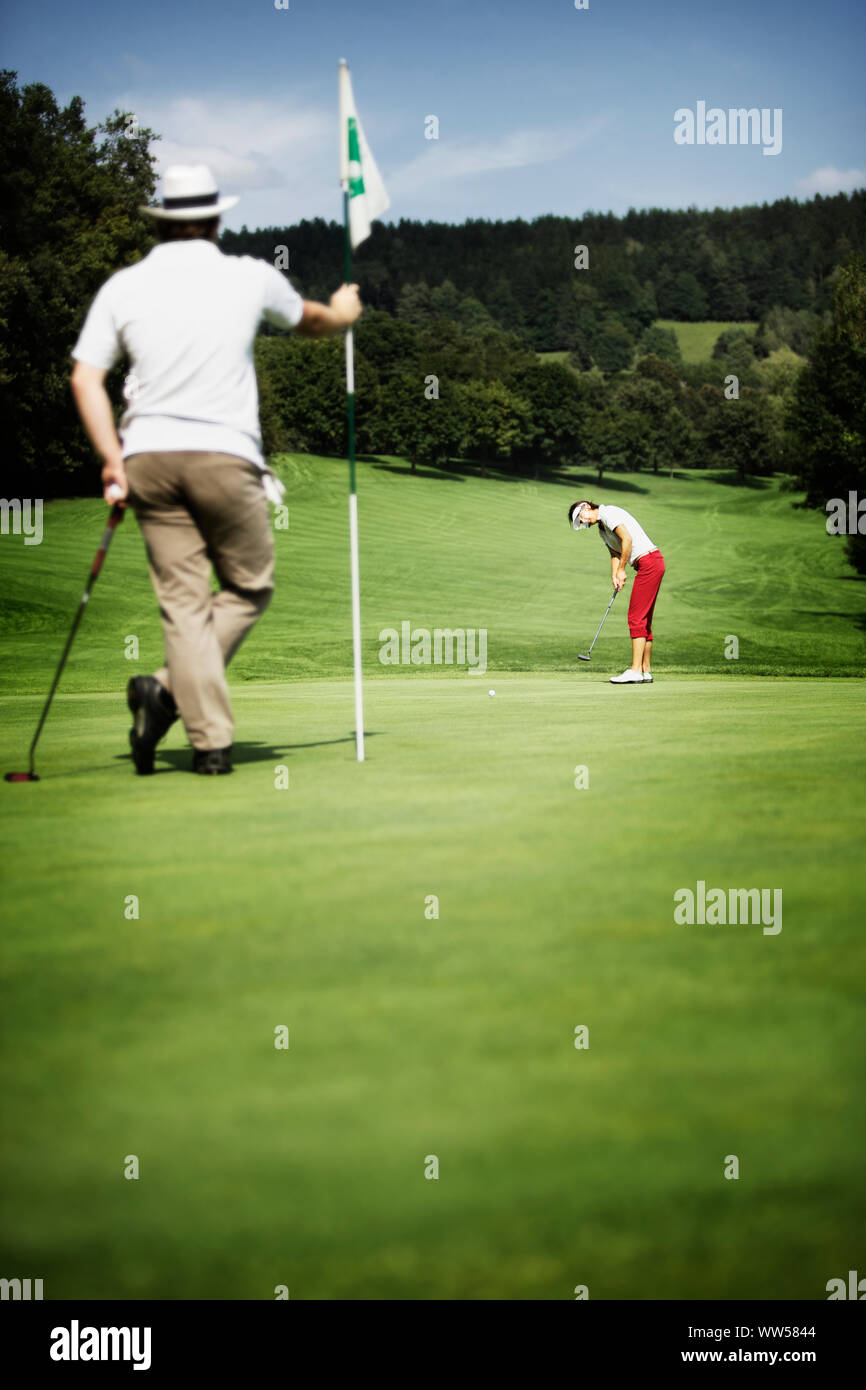 Two golfer on green Stock Photo - Alamy
