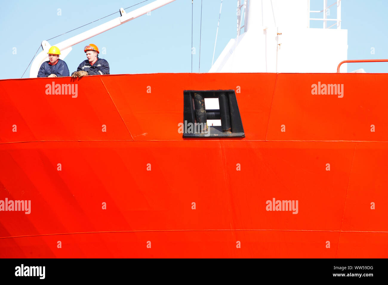 Red ship wall with workers, industrial harbour, ship, Bremen, Germany ...